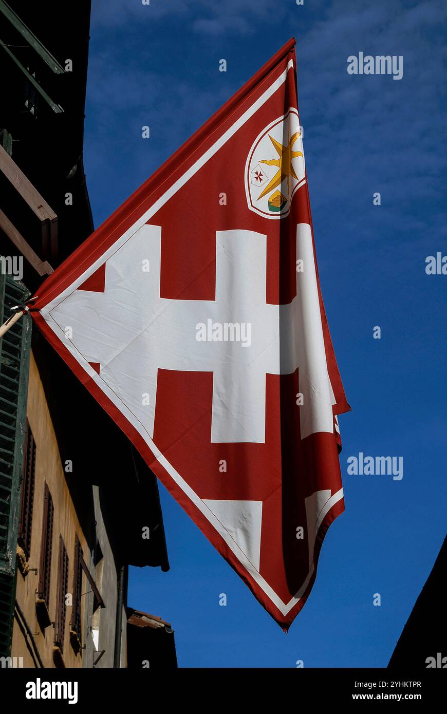 A red and white flag of the contrada (traditional district) of Porta a ...