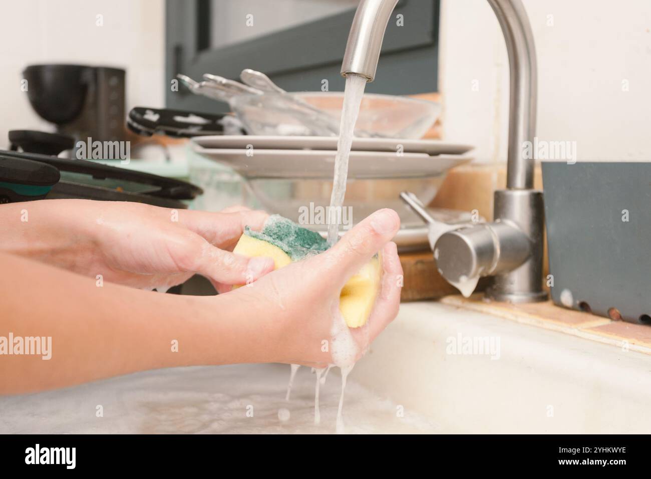 Person cleaning dirty dishes in hi-res stock photography and images - Alamy