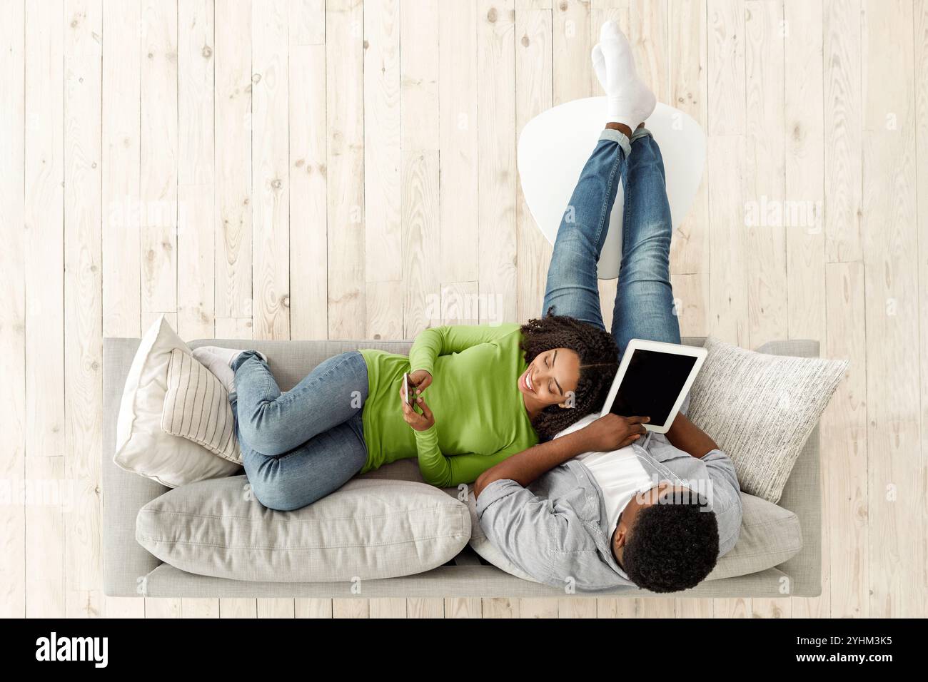 Weekend Leisure. Black Couple Relaxing On Couch With Digital Tablet And ...