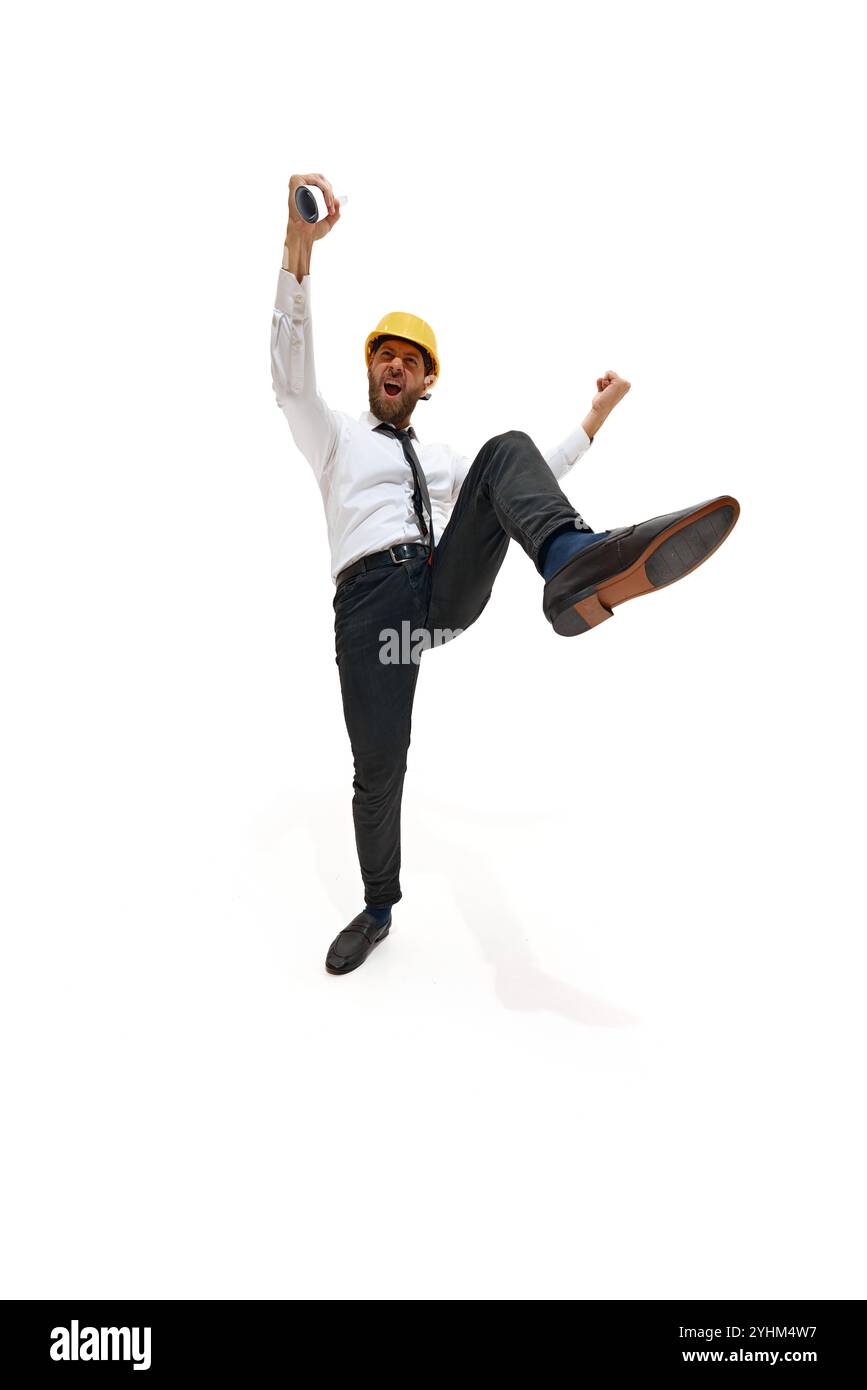 Young man dressed formal wear with builder-helmet expressing excitement ...