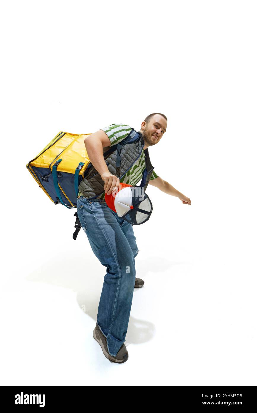 Wide angle shot of young man dressed as courier, with yellow Food ...
