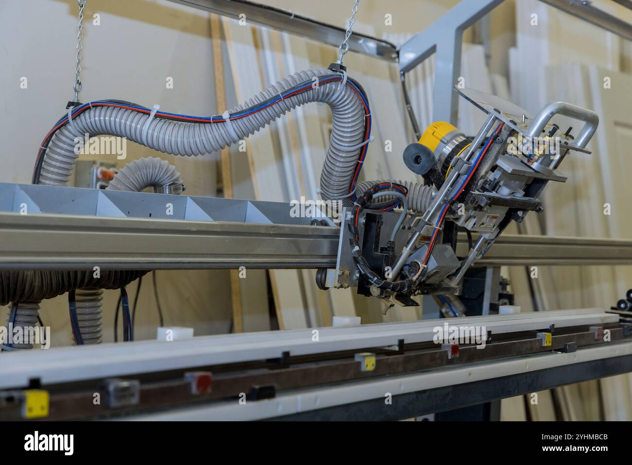 An industrial woodworking setup with robotic CNC machine arm equipped ...