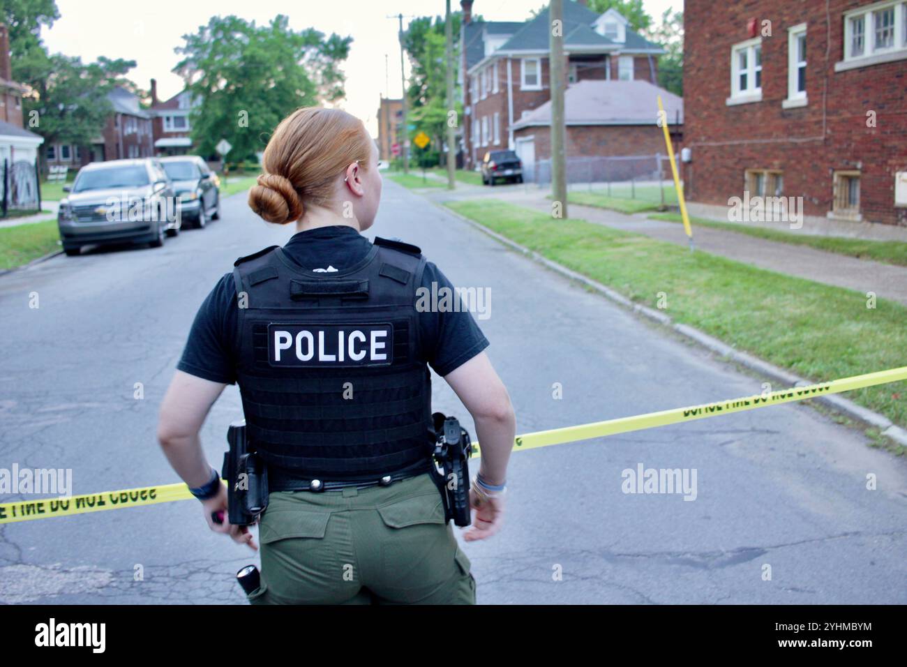 A Detroit police Special Ops officer stands guard over a crime scene ...