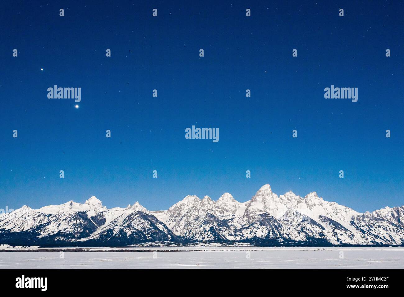 Venus and Jupiter, in a rare alignment, shine above the Teton Mountains ...
