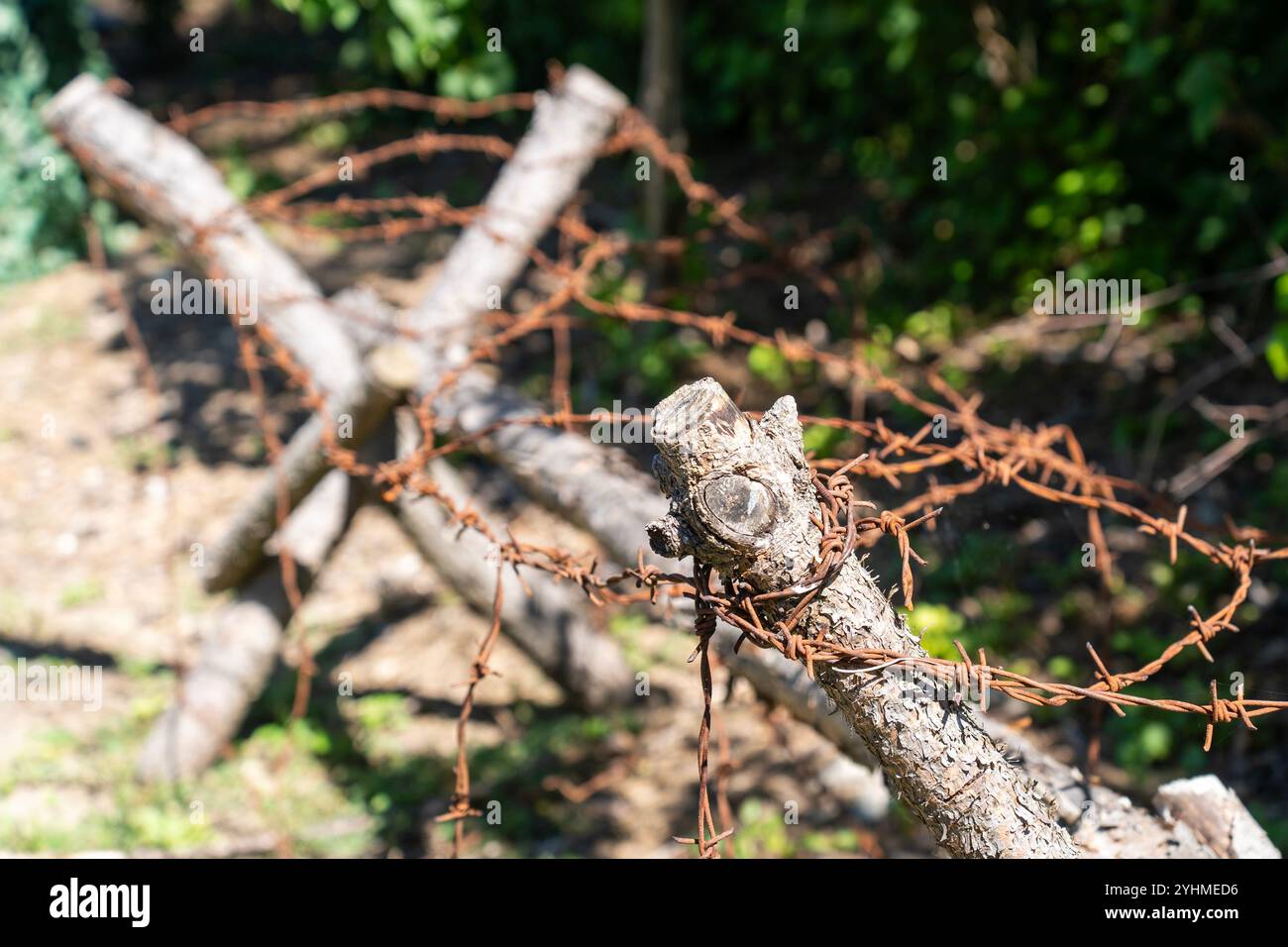 Old rusty barbed wire barrier on wooden posts Stock Photo - Alamy