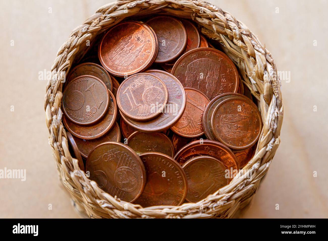 Euro coins of different values in a wicker basket Stock Photo - Alamy