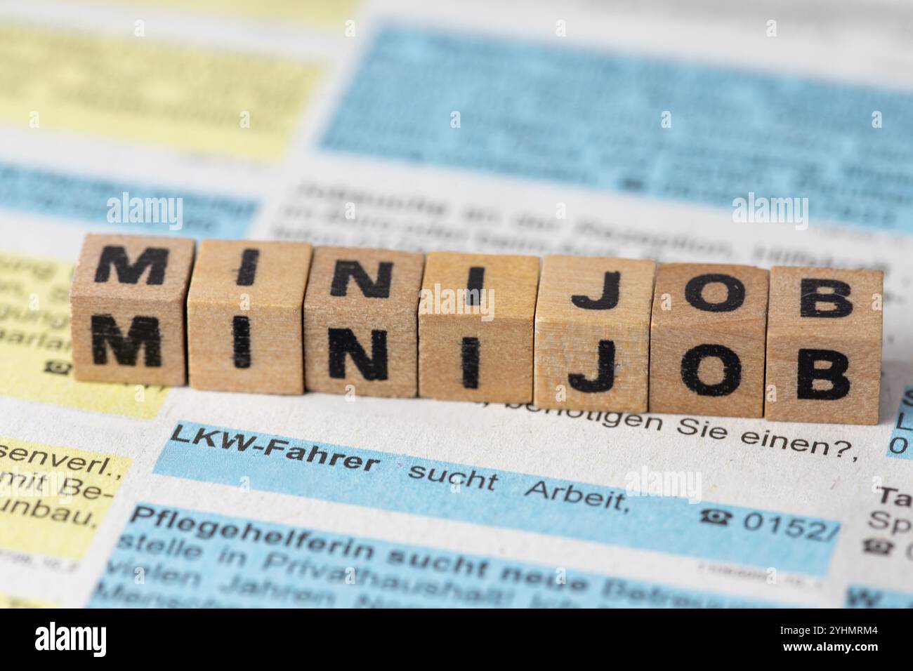 Minijob symbol: Letter cubes on newspaper classified adverts show the ...