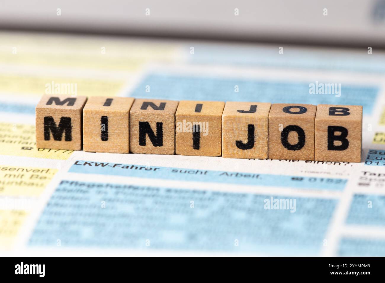 Minijob symbol: Letter cubes on newspaper classified adverts show the ...