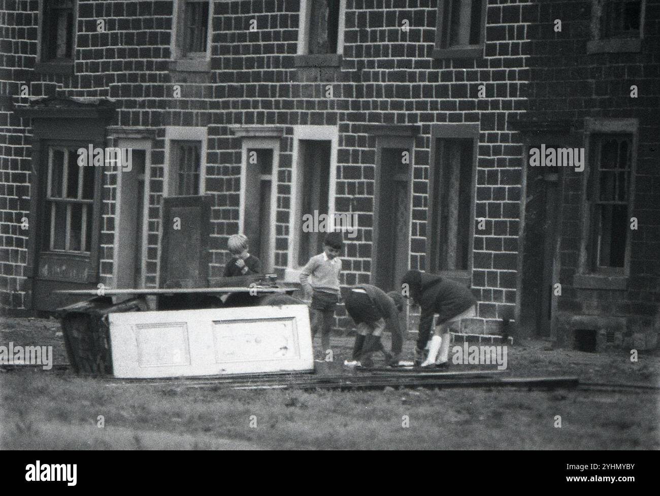 Children playing with rubbish, Burnley, Lancashire, 1969 Stock Photo ...