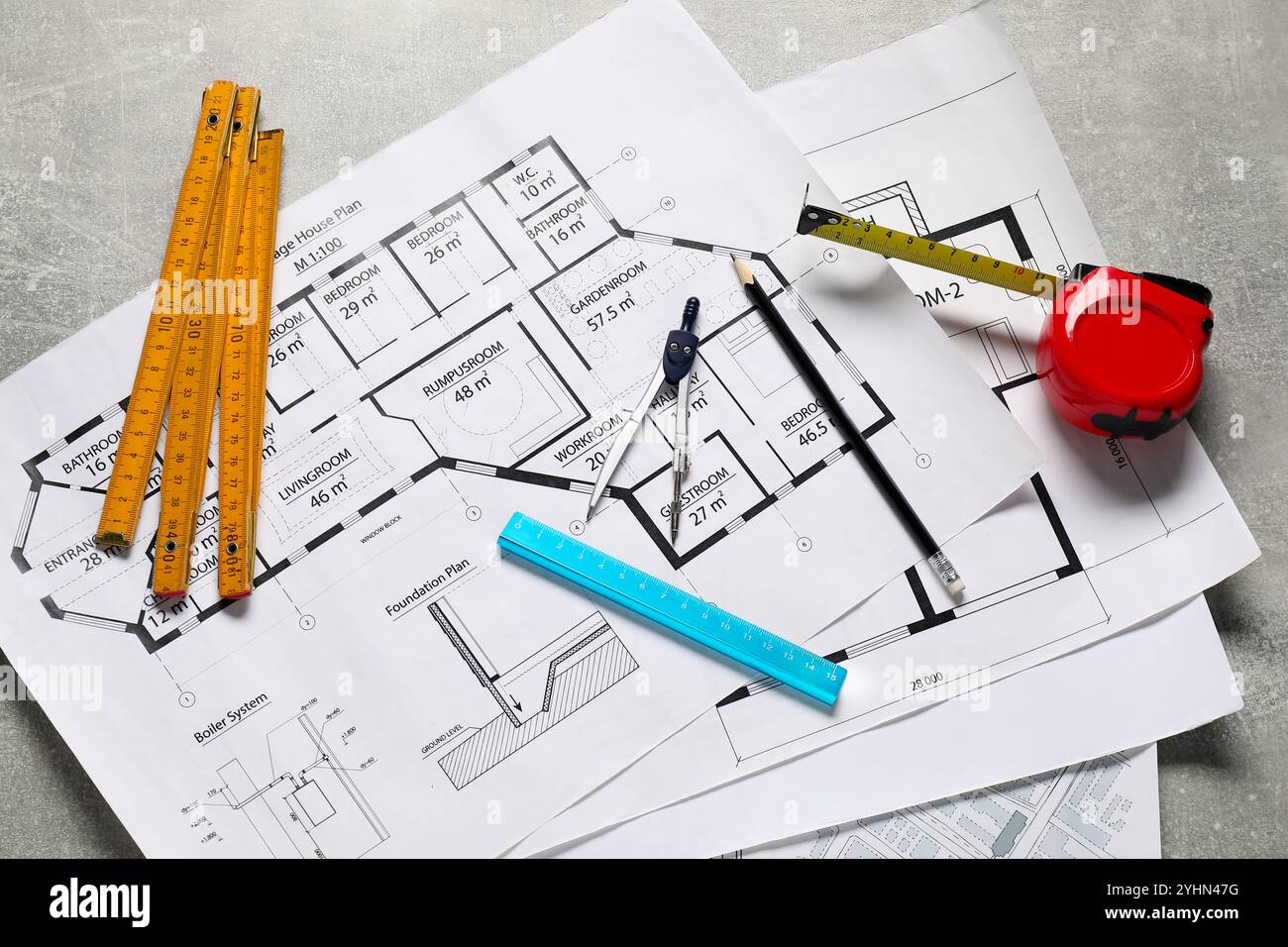 Different engineering drawings and tools on grey textured table, flat ...