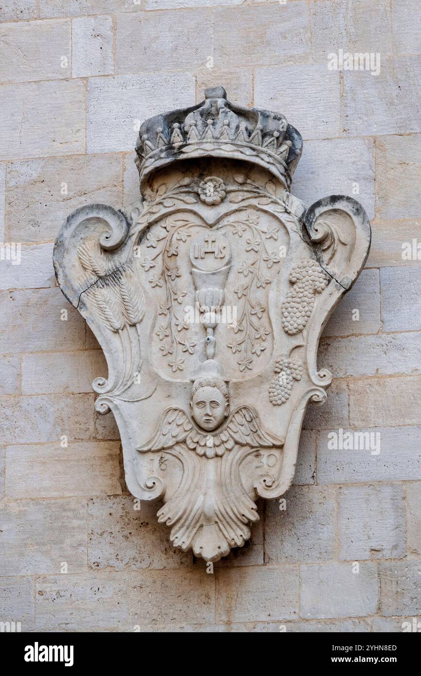 Ornate 1630 stone coat of arms featuring Eucharistic symbols on the ...