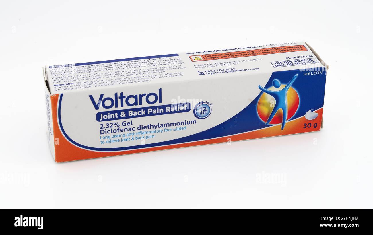Box with tube of Voltarol pain relieving ointment on white background ...
