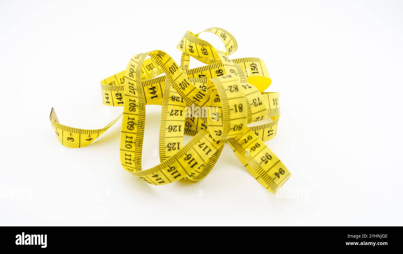 Loose metric measuring tape on white background Stock Photo - Alamy