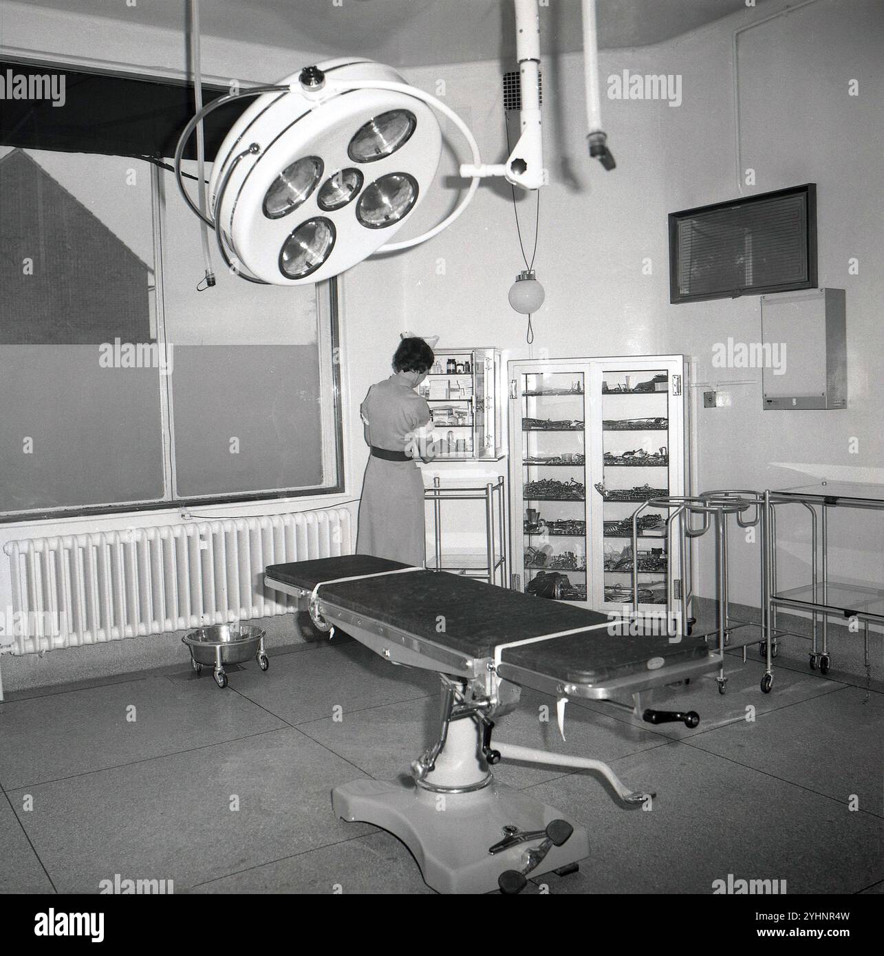 1979, historical, inside a hospital operating room or theatre, a nurse ...