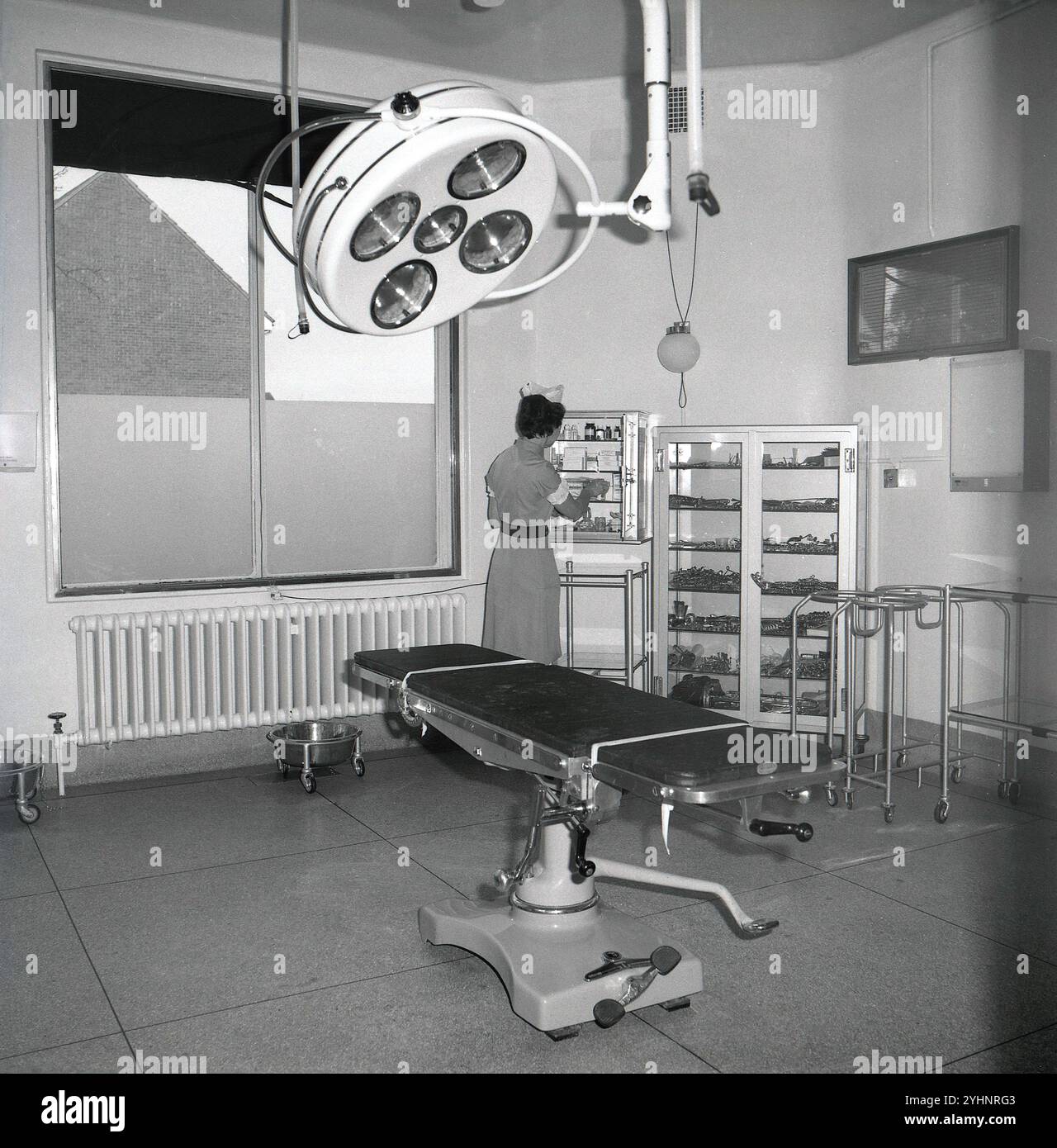 1979, historical, nurse, a theatre sister, at an open medical cabinet ...