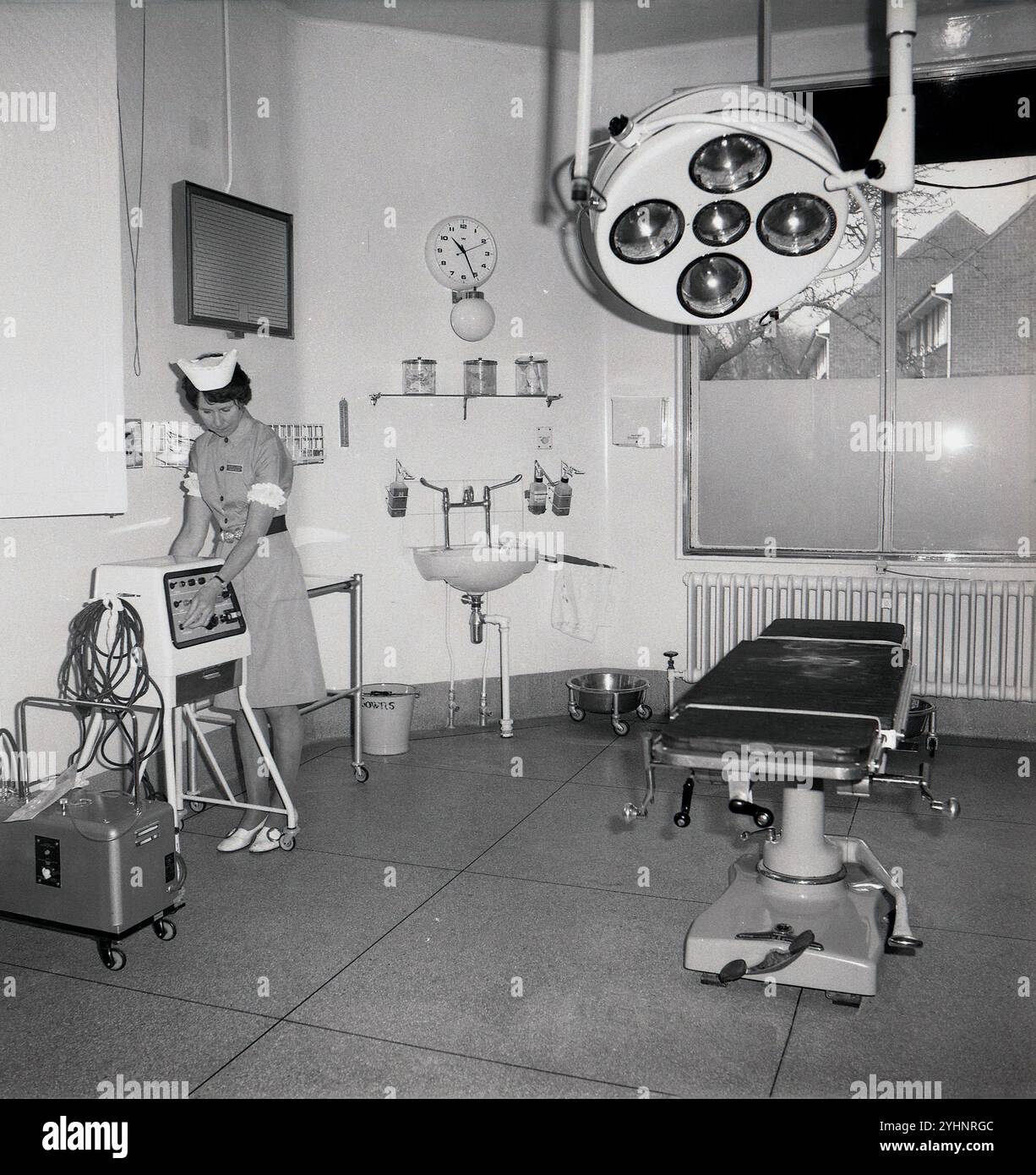 1979, historical, nurse beside a machine inside a hospital operating ...