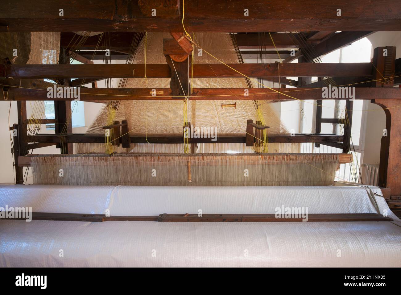 Ancient wooden silk weaving loom creating precious fabric in the ...