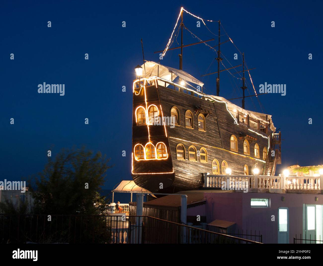 Wooden sailing ship with restaruant Sirius on sea beach at night, St ...