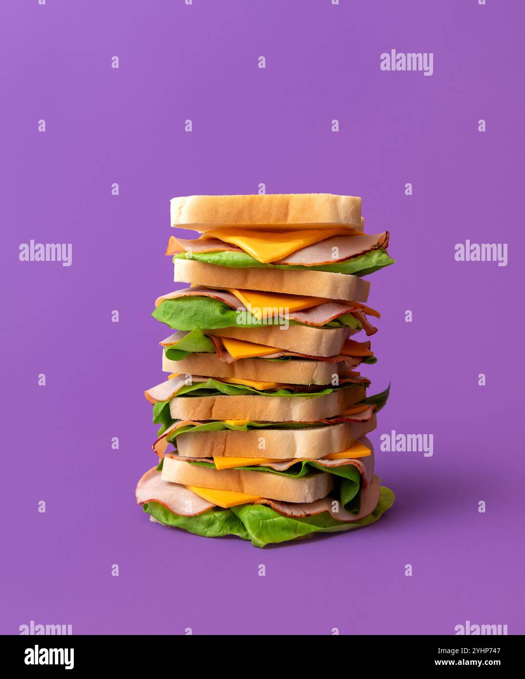 Sandwich with multiple layers of toast bread, turkey ham, cheese, and ...