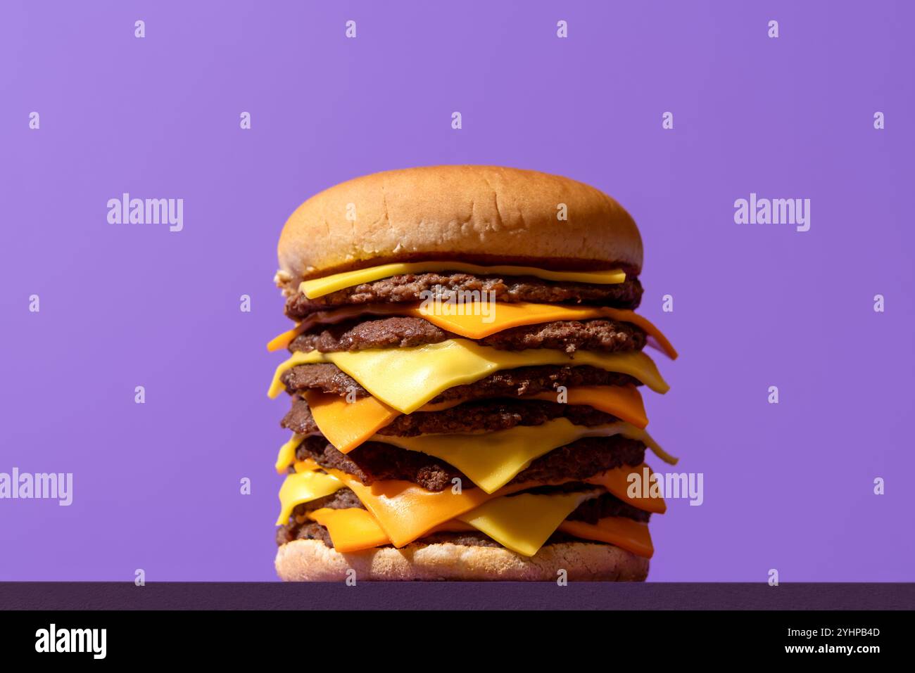 Cheeseburger with multiple layers of beef patties and cheese, isolated ...