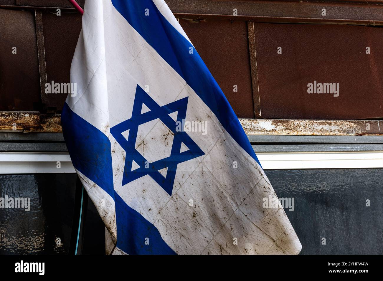 Dirty, mud stained, wrinkled blue and white flag of the State of Israel ...