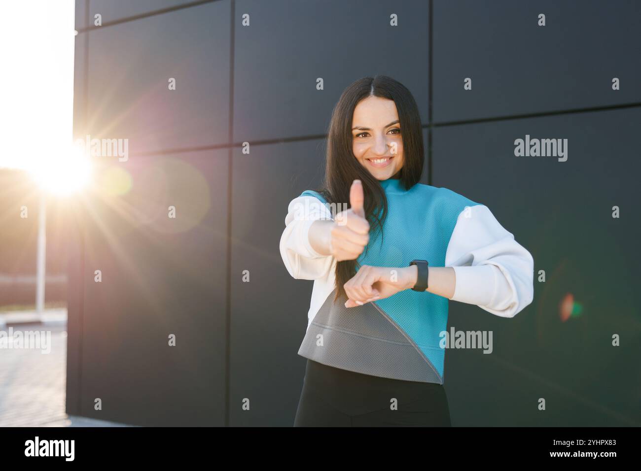 Cute sporty girl smiling cutely and showing good job gesture while ...