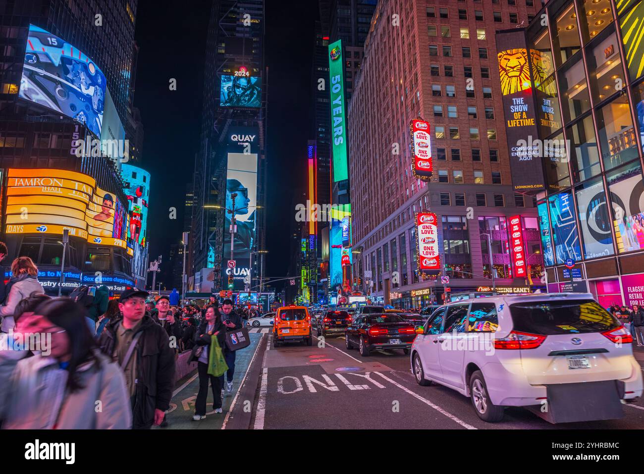 Busy Times Square at night with illuminated billboards, crowds of ...