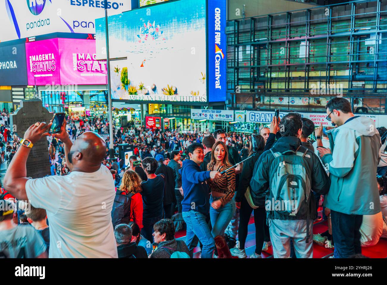 Busy Times Square in New York City with crowd of tourists taking ...