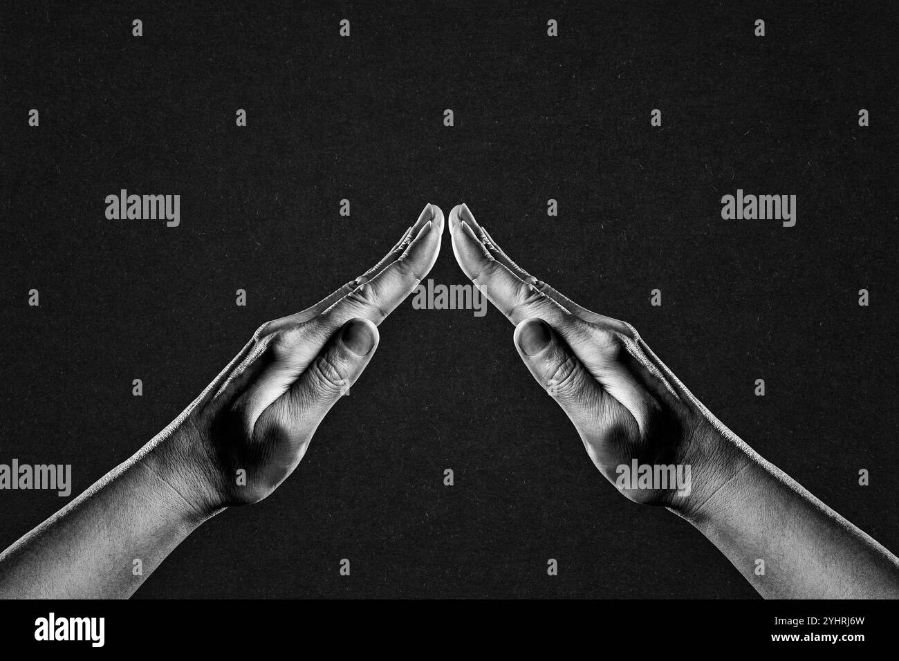 Hands in Black and White in Gesture of Protection, Care Sign on Black Textured Background with ...