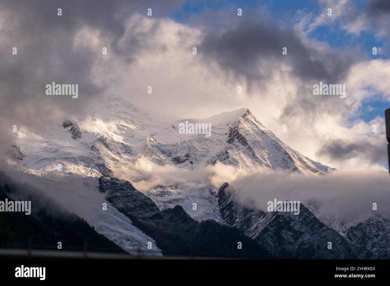 Mont-Blanc shrouded in clouds at sunset in Chamonix, France Stock Photo ...