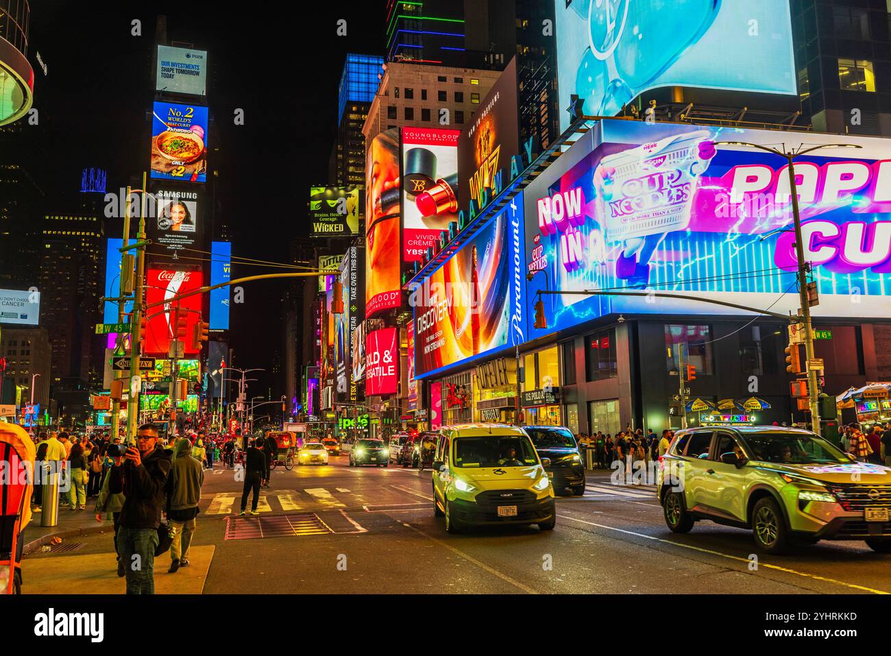 Vibrant night scene in Times Square, New York City, with illuminated ...