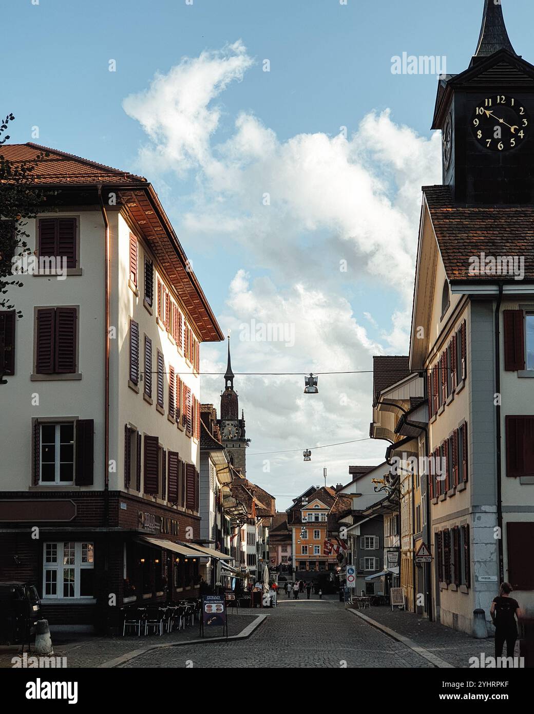 Street in the old town in the afternoon. Church in the end of the ...