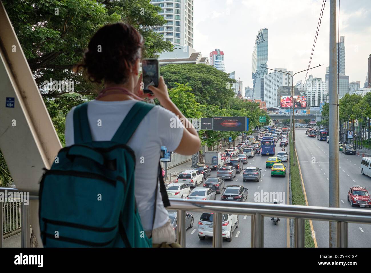 Tourist taking pictures of bangkok traffic from a footbridge Stock ...