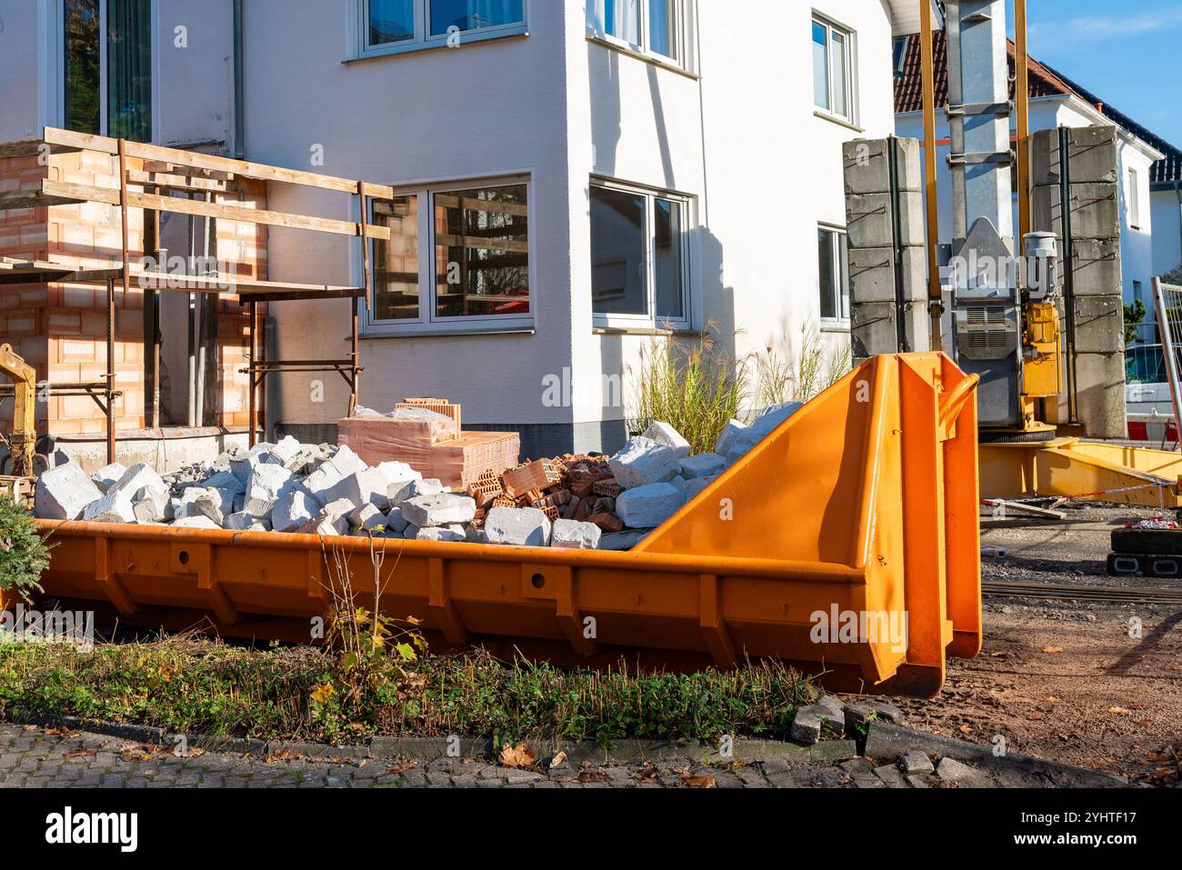 Building under construction yellow dumpster hi-res stock photography ...