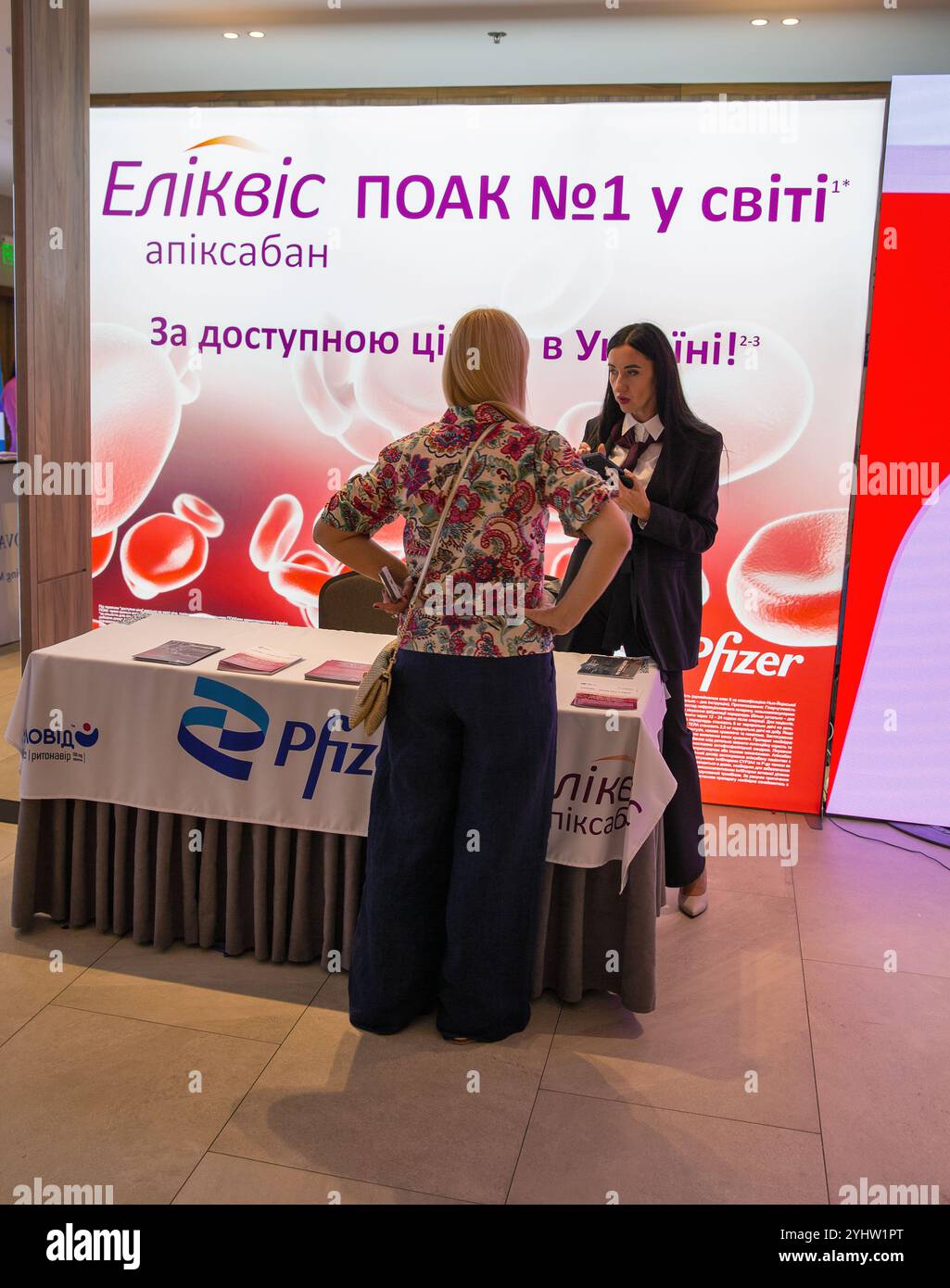 Kyiv, Ukraine - September 24, 2024: People visit Pfizer pharmaceutical company booth at XXV ...