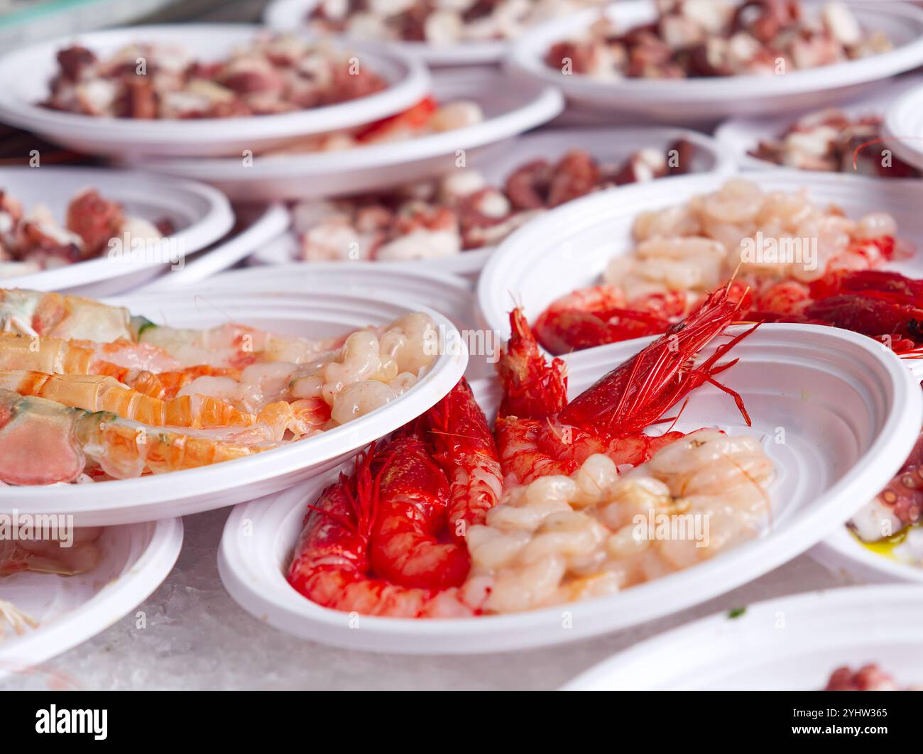 Fresh seafood served on plastic plates selective photo. Street market ...