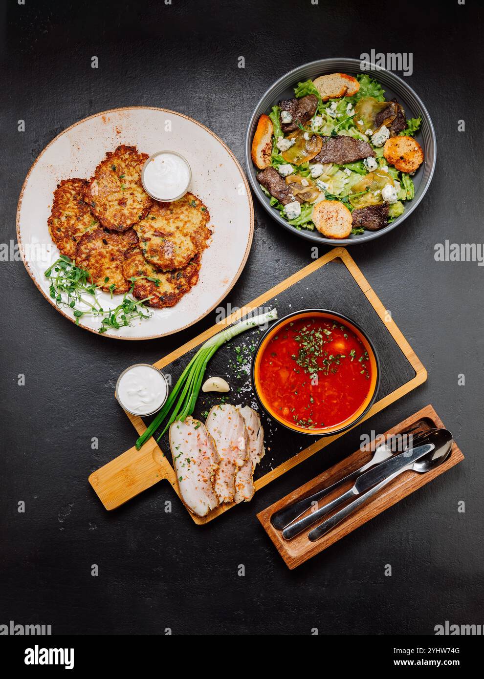 Ukrainian traditional meal spread with borscht, potato pancakes, salad ...