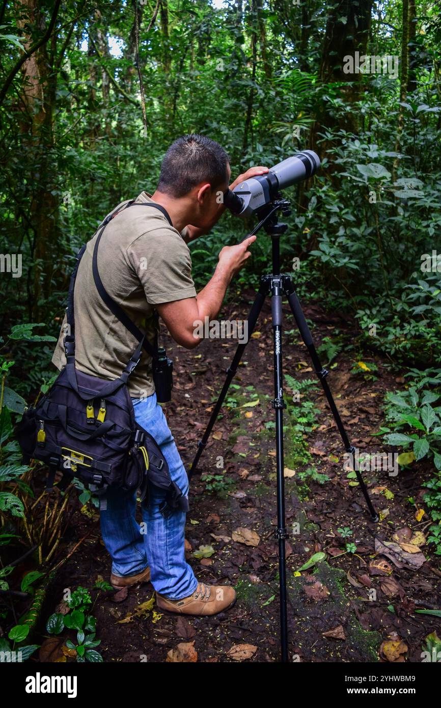 George of the Cloud Forest, guide and specialist, using a spotting ...