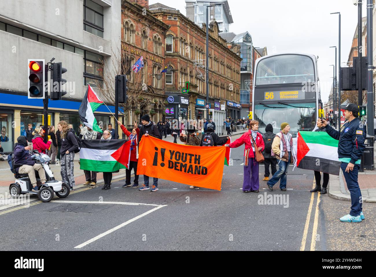 Leeds, UK. 12 NOV, 2024. Youth Demand group holding banners, signs and ...