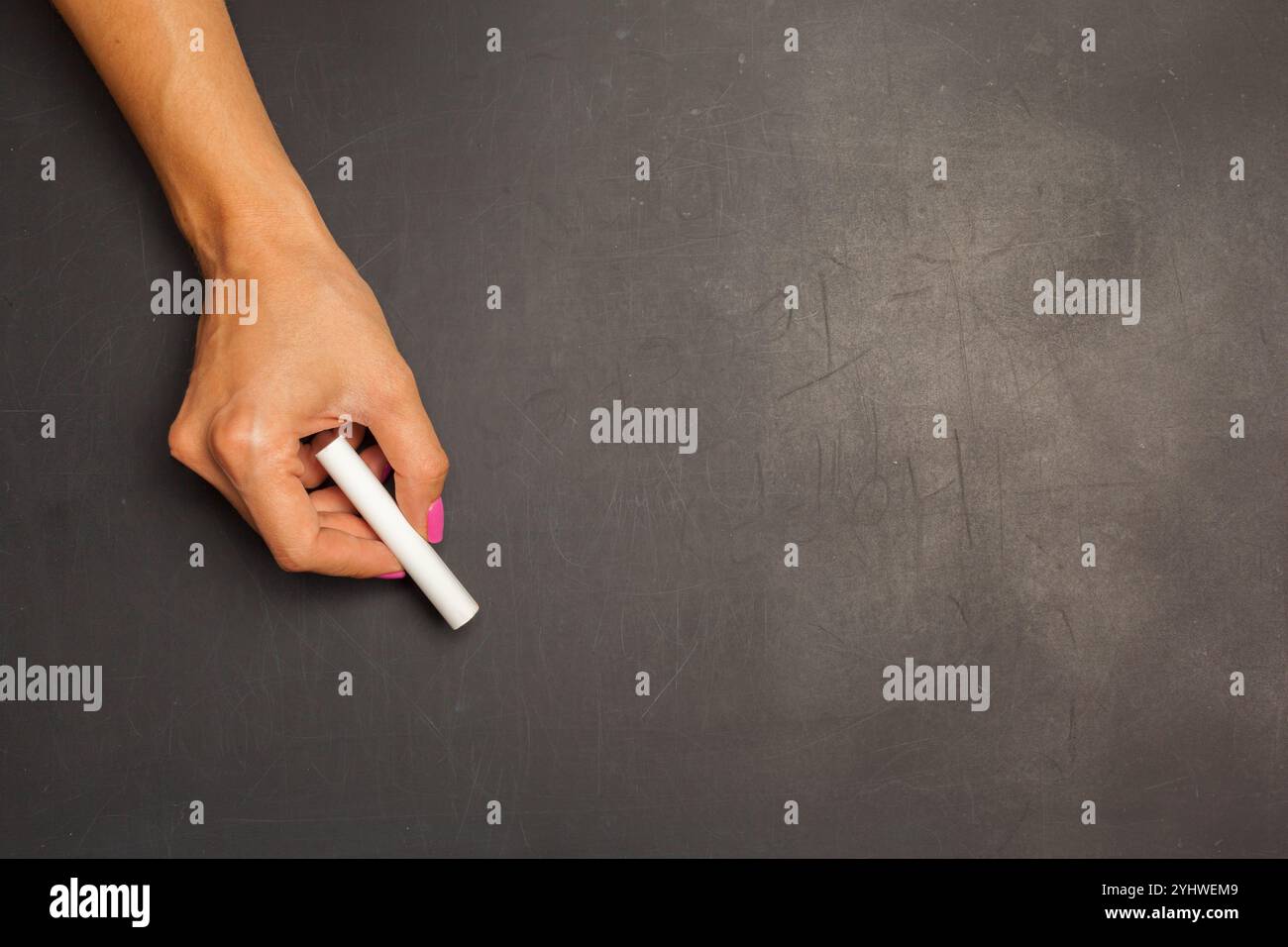 Hand holding chalk piece Stock Photo - Alamy