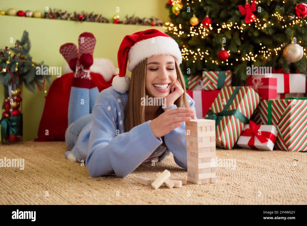 Photo of young beautiful alone girl wearing blue sweater and red santa ...