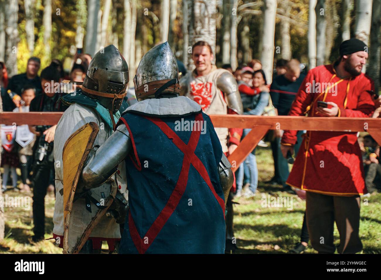 Knights in armor and helmets, fighting with swords and shields in the ...