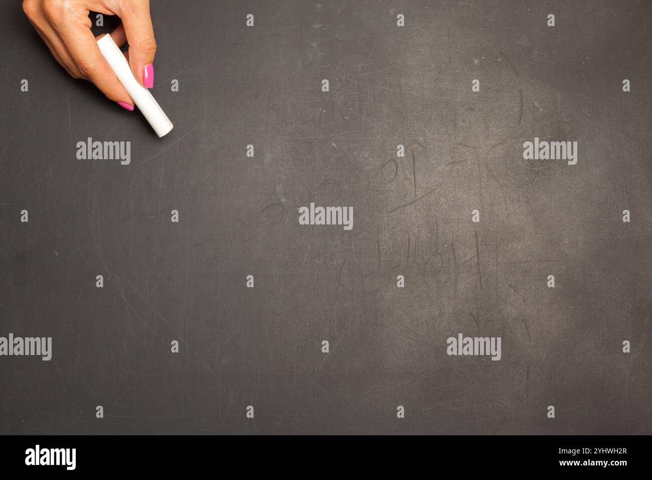 Hand holding chalk piece Stock Photo - Alamy
