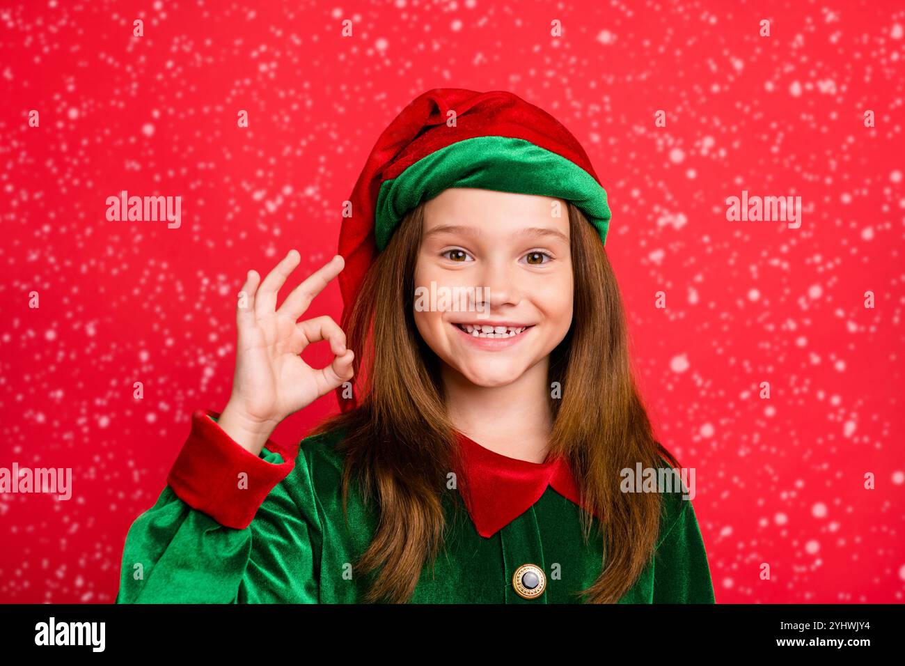 Close up photo of charming elf kid in green hat with long red head ...