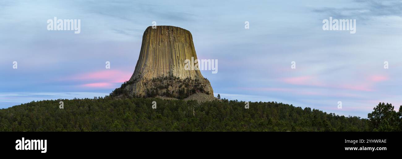 Sunset casts a subtle pink glow on clouds behind Devil's Tower in Devil ...