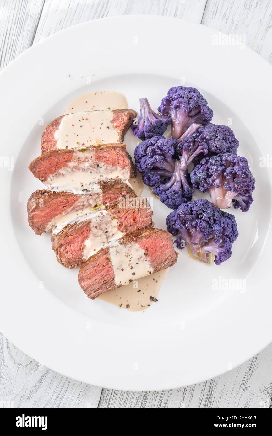 Portion of beef steak with purple cauliflower Stock Photo - Alamy