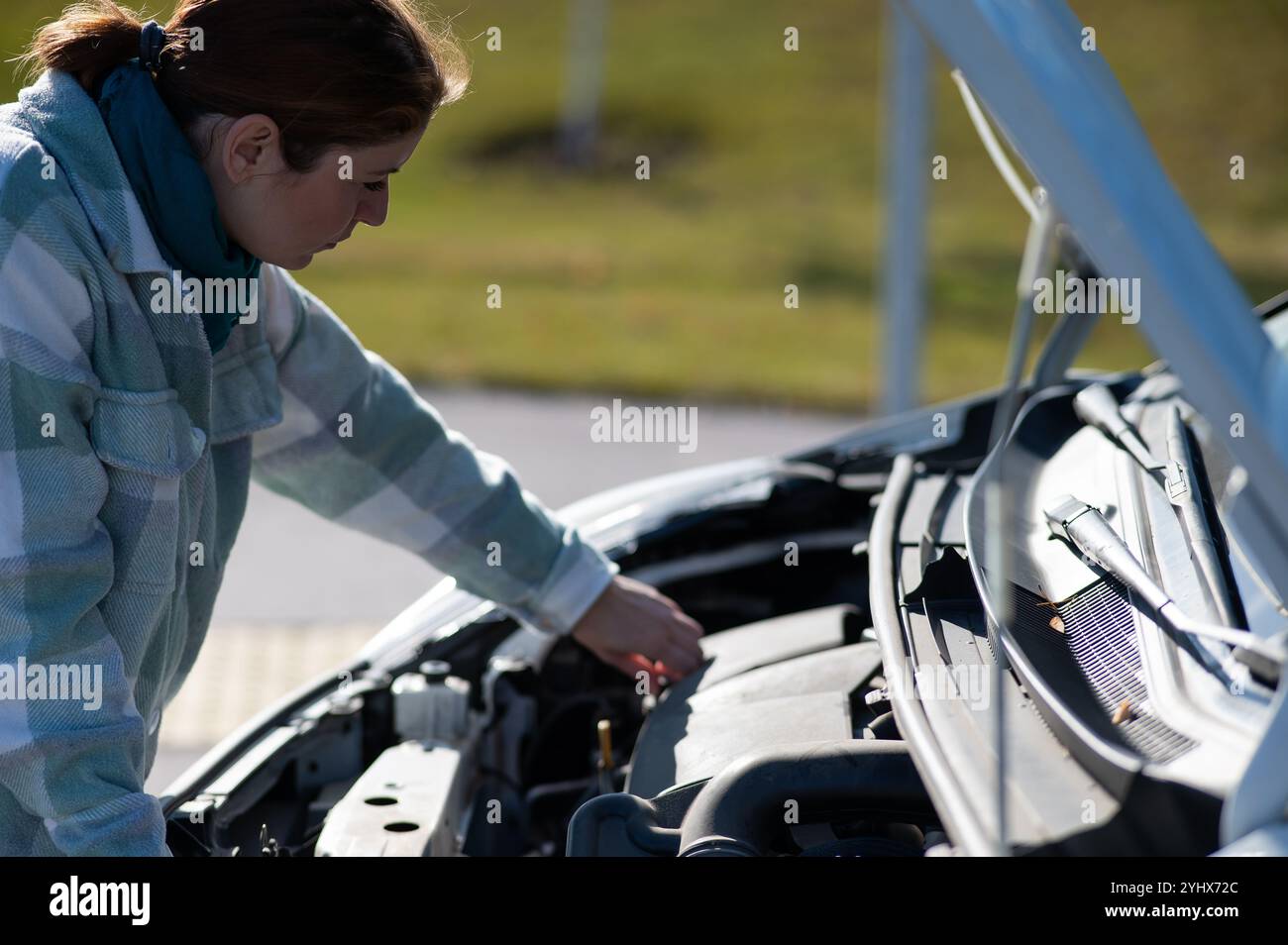 Woman checking oil level hi-res stock photography and images - Alamy