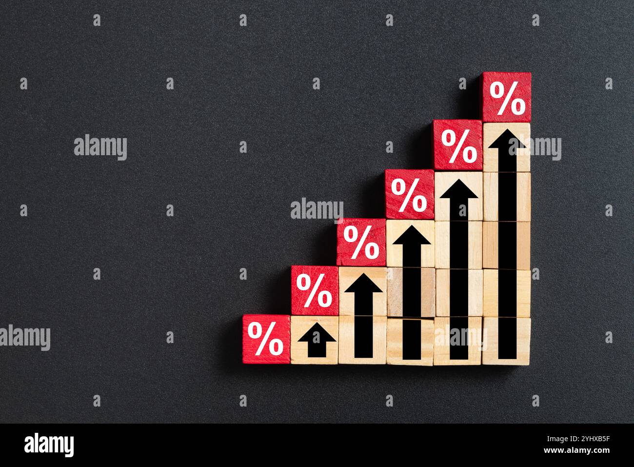 Red wooden blocks arranged as a bar graph with upward arrows and ...