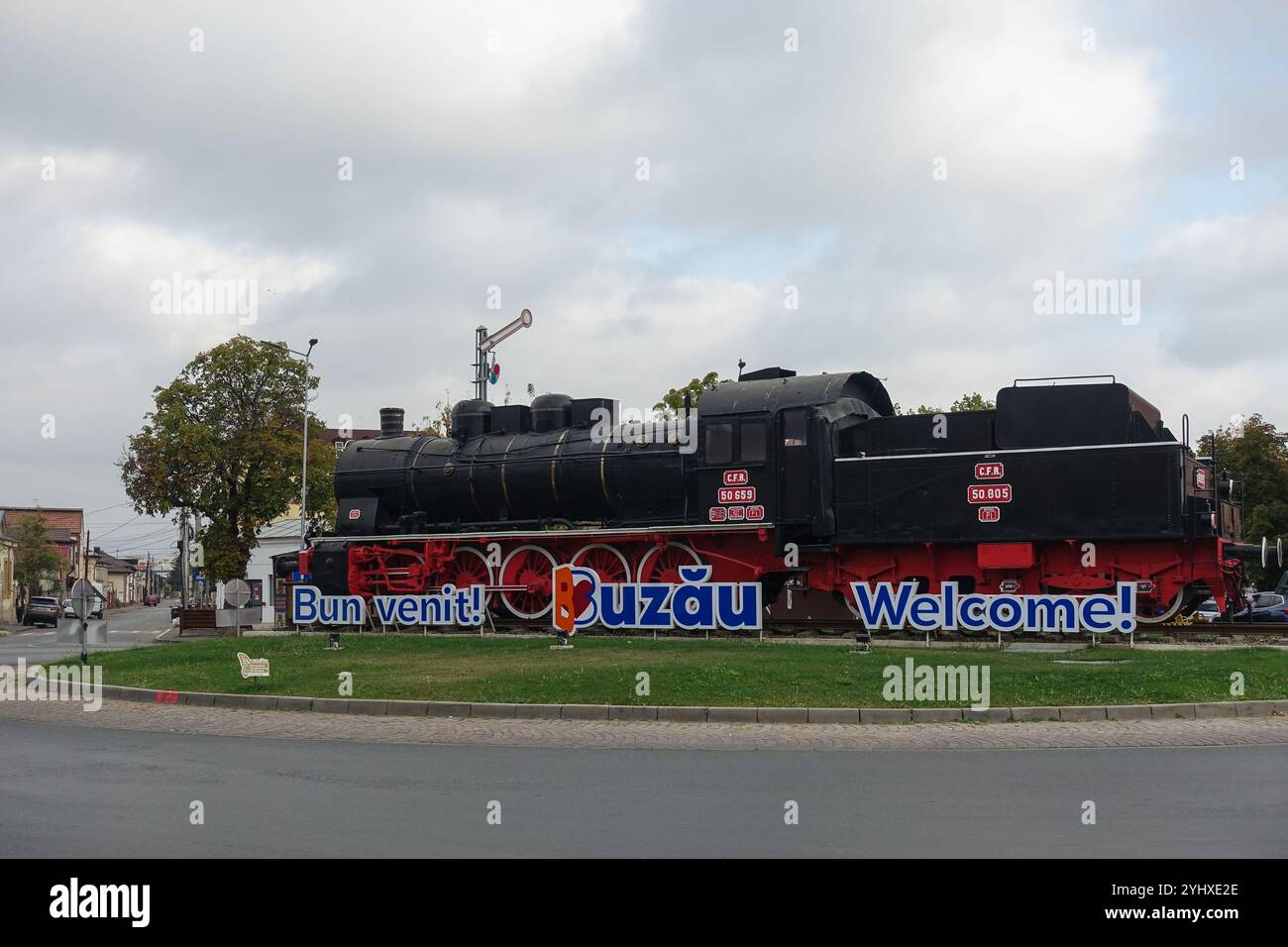 Historic black steam locomotive displayed on a roundabout with welcome ...