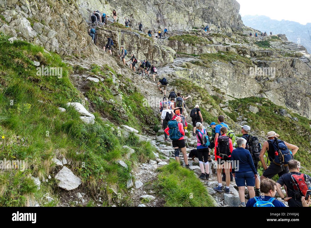 Group of hikers queing to climb up Mount Rysy (2501m), highest summit ...